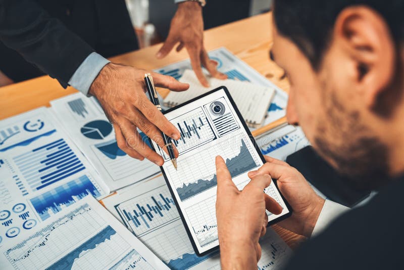 Busy Analyst Team Discussing Financial Data on Tablet. Fervent Stock ...