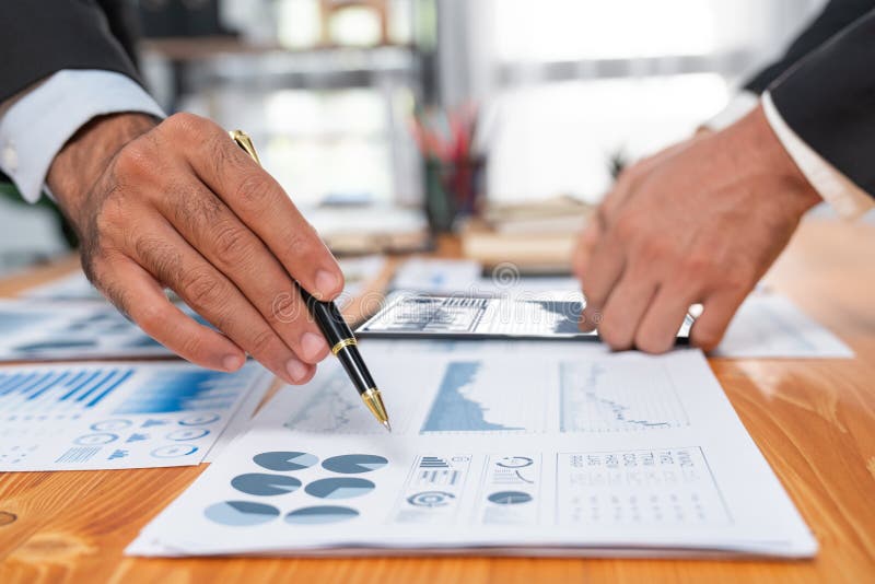 Busy Analyst Team Discussing Financial Data on Tablet. Fervent Stock ...