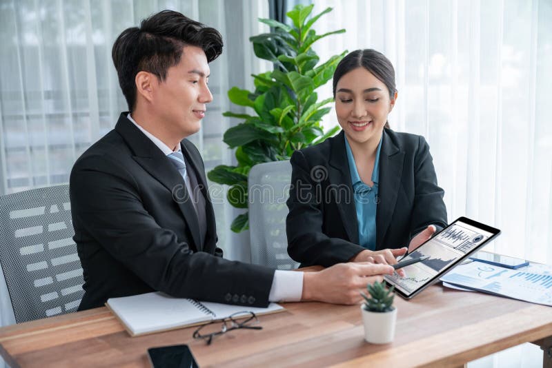 Busy Analyst Team in Office Discuss Data Analysis on Tablet Screen ...