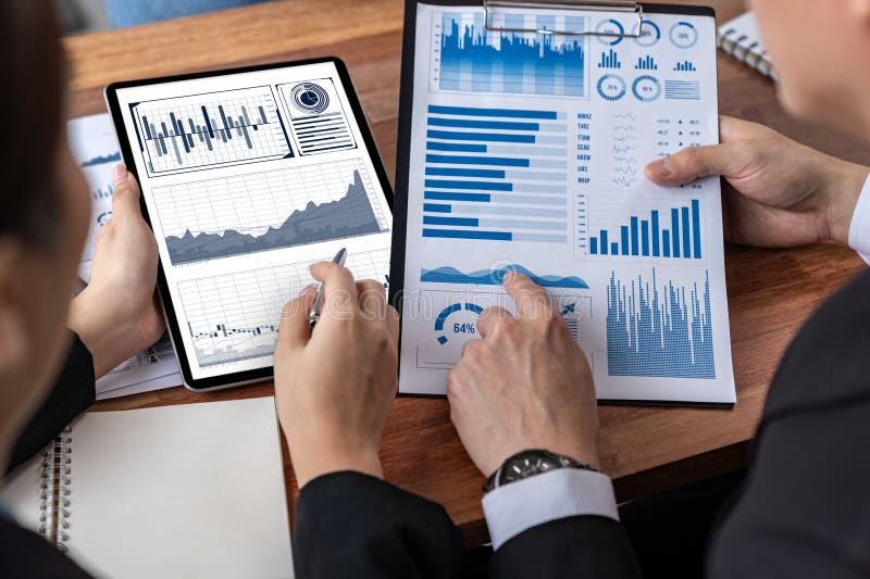 Busy Analyst Team in Office Discuss Data Analysis on Tablet Screen ...