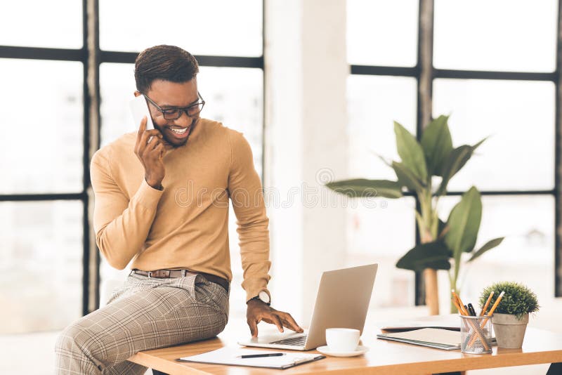 Busy Black Guy Taking on Cellphone Using Computer Stock Photo - Image ...