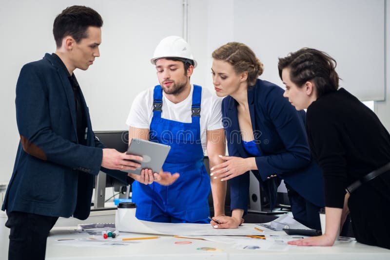 A Busy Construction Design Team Having a Meeting Stock Photo - Image of ...