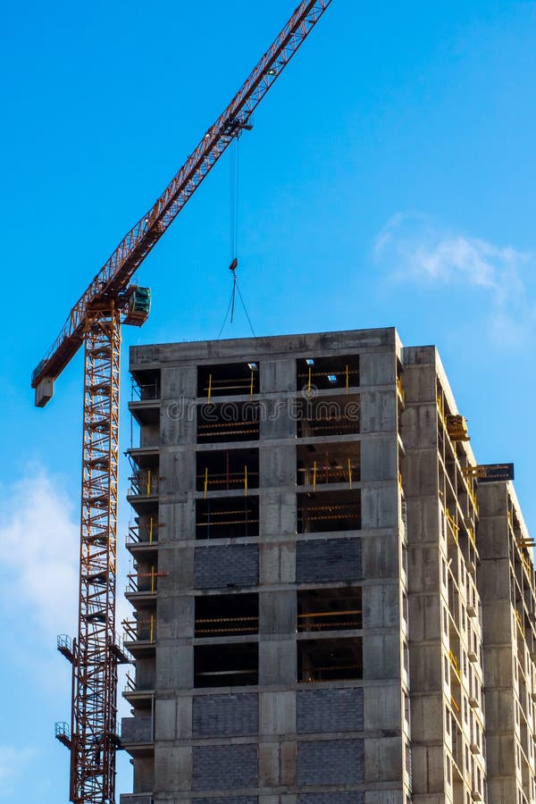 A Busy Construction Site with Cranes and a Building in Progress ...