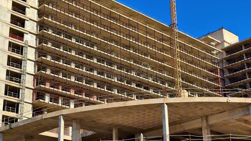 A Busy Construction Site Featuring Cranes, a Building Structure, and ...