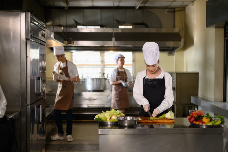 Busy Cooking Class in Session with Multiple Students in Uniforms ...