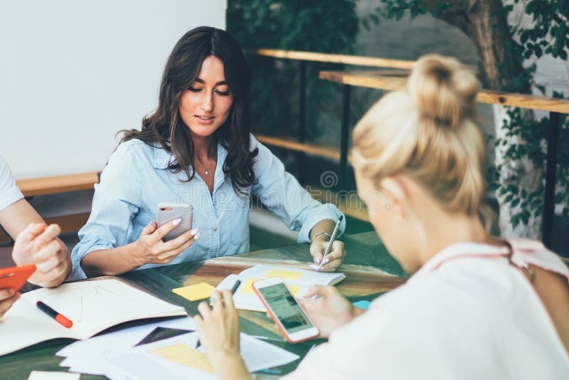 Busy Coworkers Using Gadgets for Work in Workplace Stock Photo - Image ...