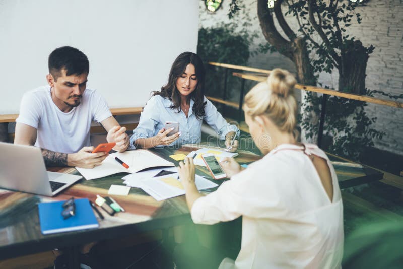 Busy Coworkers Using Gadgets for Work in Workplace Stock Image - Image ...
