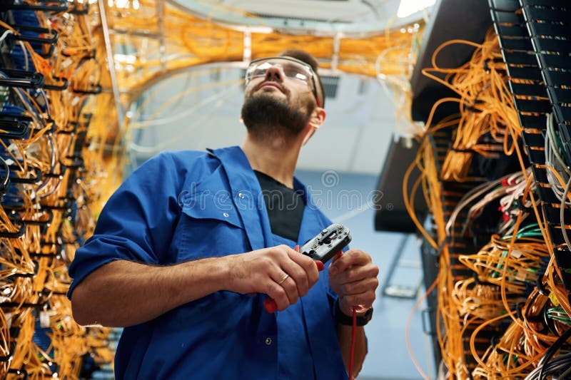 Busy by Cutting the Wire. Young Man is Working with Internet Equipment ...