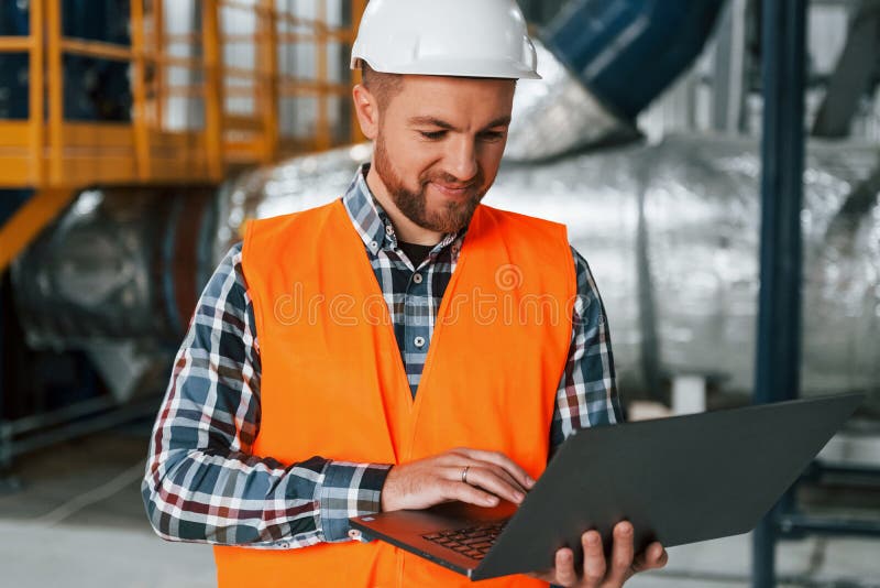 Busy Day. Construction Worker in Uniform is in the Factory Stock Photo ...