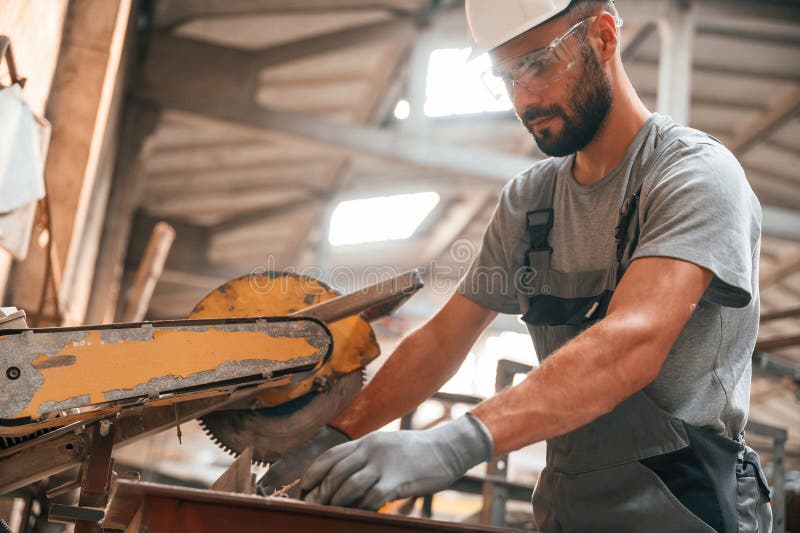Busy Day. Young Factory Worker in Grey Uniform Stock Photo - Image of ...