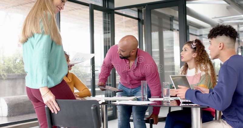 Busy Diverse Architects Discussing Blueprints on Table in Office, Slow ... Busy Diverse Architects Discussing Blueprints on Table in Office, Slow ...