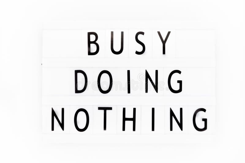 Busy Doing Nothing, Inspirational Text Written on a Light Box Stock ...