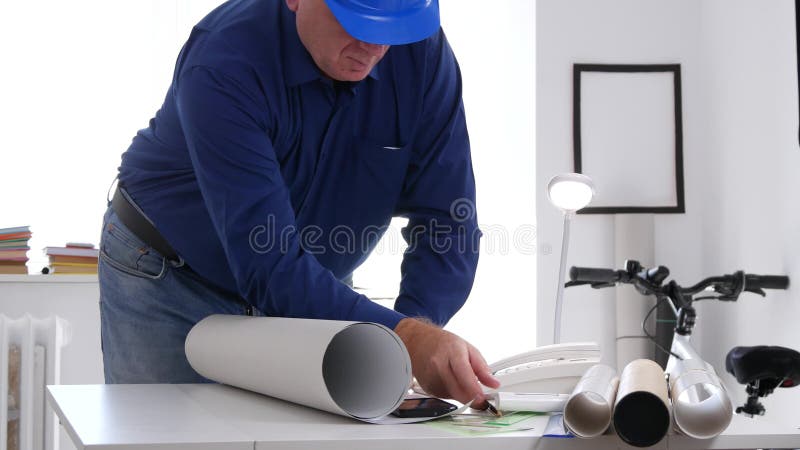 Busy Engineer in Office Open a Plan on the Table and Study Technical ...