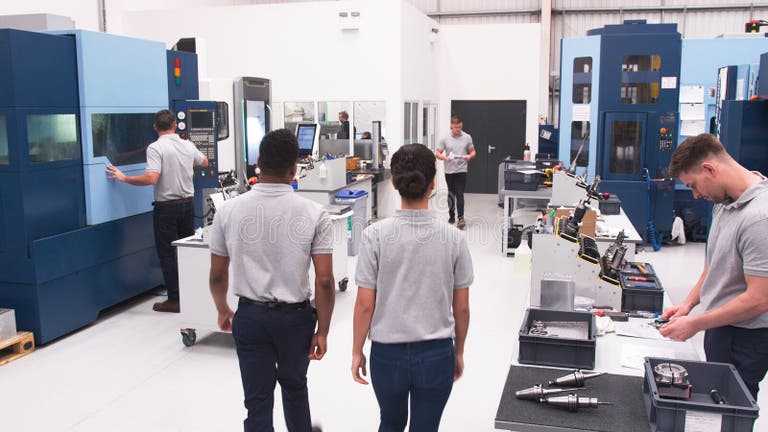 Busy Engineering Workshop with Workers Using CNC Machinery Stock Image ...