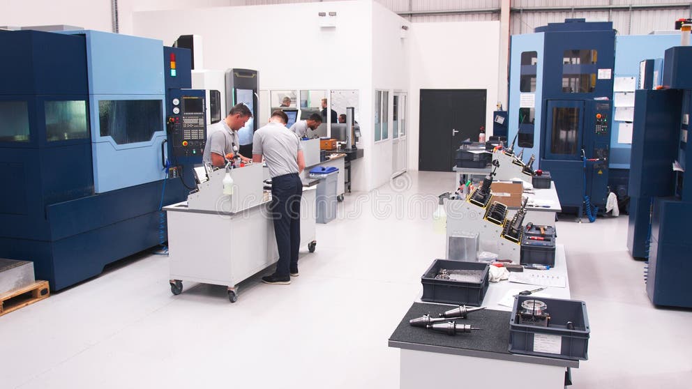 Busy Engineering Workshop with Workers Using CNC Machinery Stock Photo ...