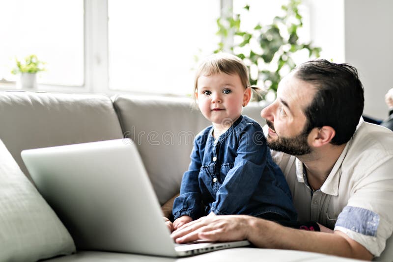Busy Father Working on Laptop with Baby in Front Stock Photo - Image of ...