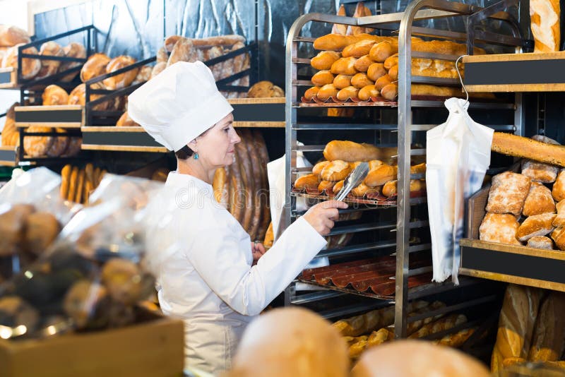 Busy Female Baker with Fresh Bread in Bakery Stock Photo - Image of ...