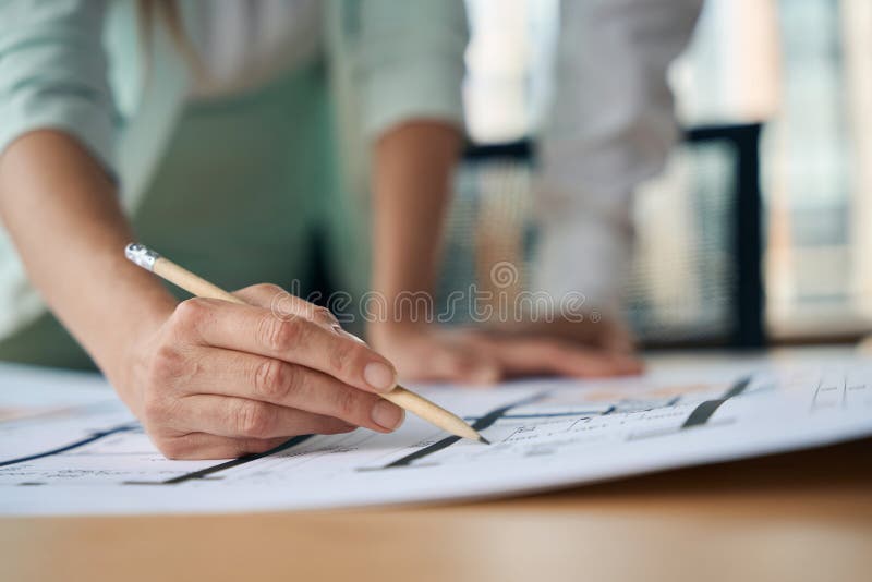 Busy Female Office Worker Implementing Changes into Plan with Pencil ...