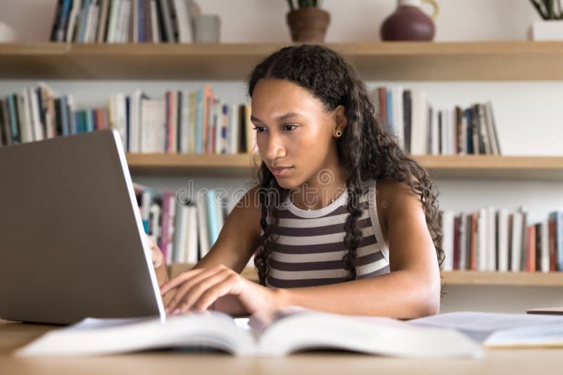 Busy Female Student Studying at Library Typing on Notebook Stock Photo ...