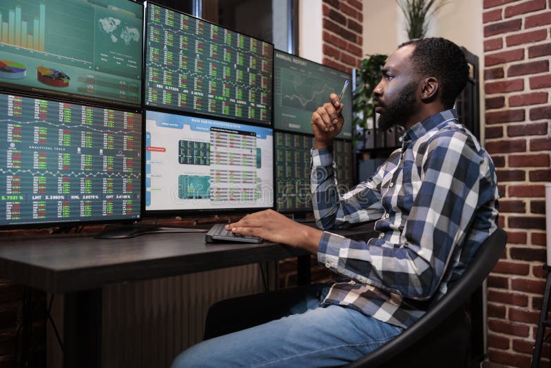 Busy Hedge Fund Trader Reviewing Financial Data and Market Trend while ... Busy Hedge Fund Trader Reviewing Financial Data and Market Trend while ...