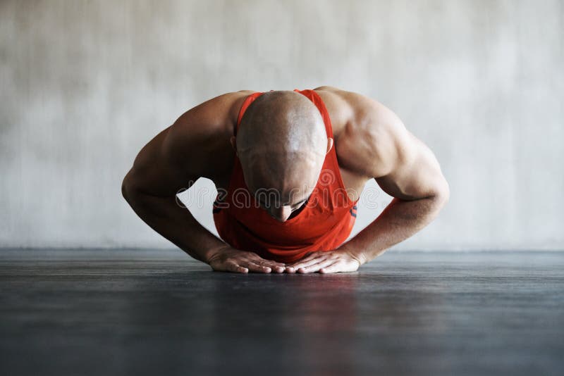 Busy with an Intense Workout. Shot of a Man Working Out at the Gym ...