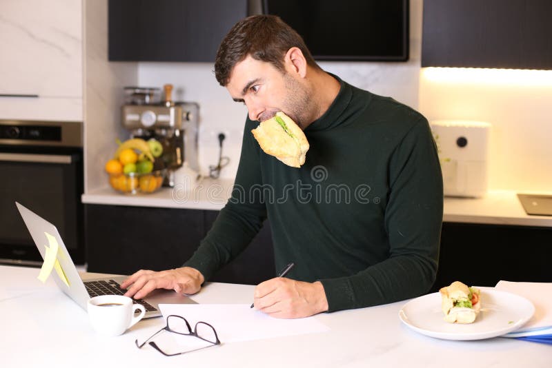Busy Man Eating a Sandwich while on Conference Call Stock Photo - Image ...