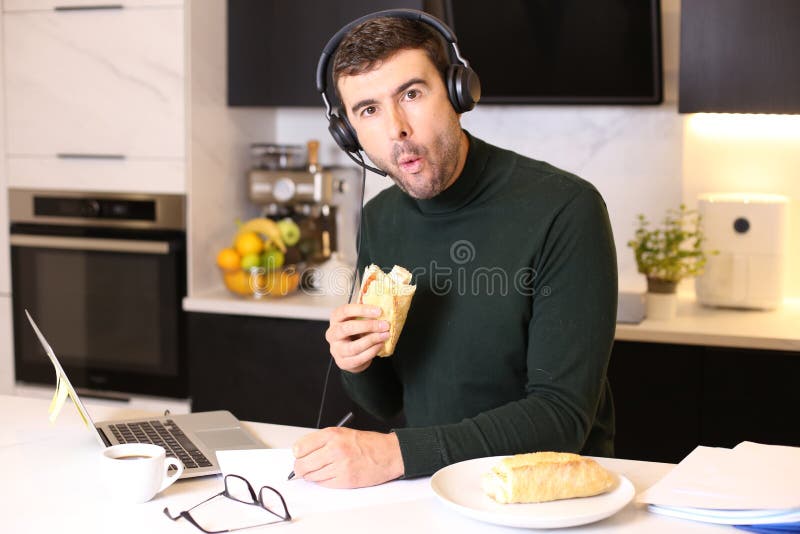 Busy Man Eating a Sandwich while on Conference Call Stock Photo - Image ...