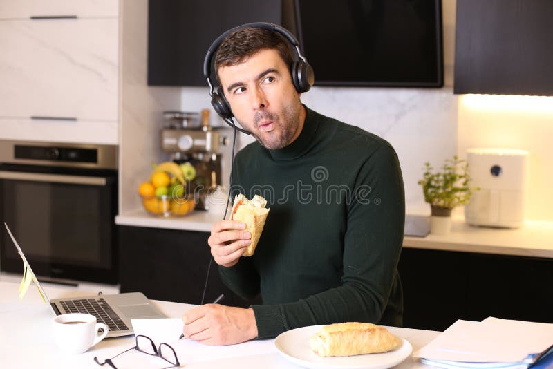 Busy Man Eating a Sandwich while on Conference Call Stock Image - Image ...