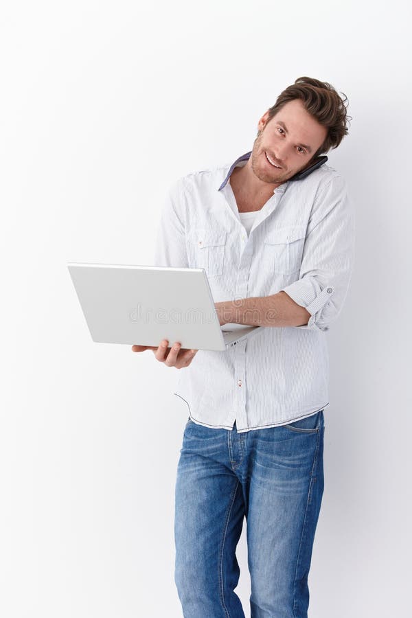 Busy Man with Mobile and Laptop Smiling Stock Photo - Image of busy ...