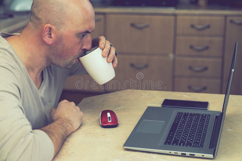 Busy Man Working at Home. Man Sitting at Home, Working on Laptop ...