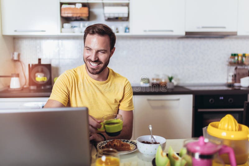 Man Working at Home, Using Laptop while Having Breakfast Stock Image ...