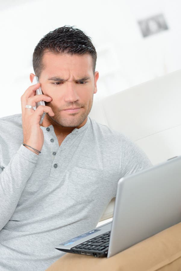 Busy Man with Working on Laptop and Using Mobile Phone Stock Photo ...