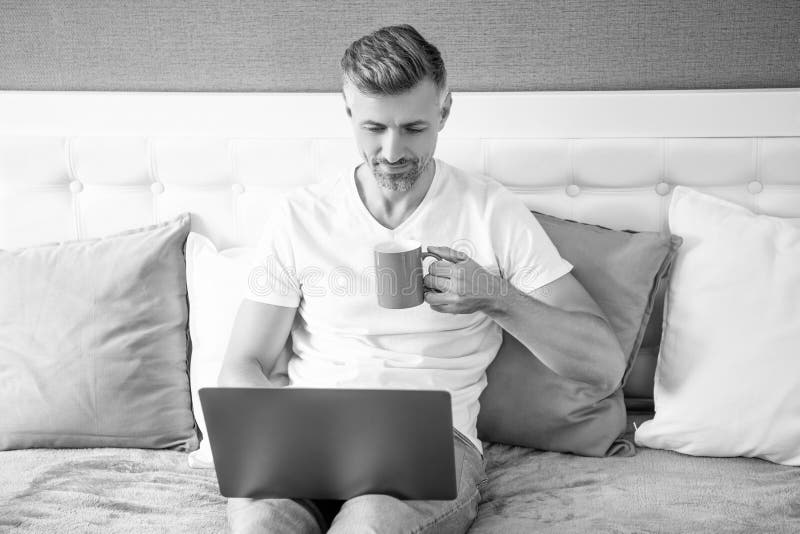 Busy Mature Man Using Computer in Bed with Coffee Stock Photo - Image ...