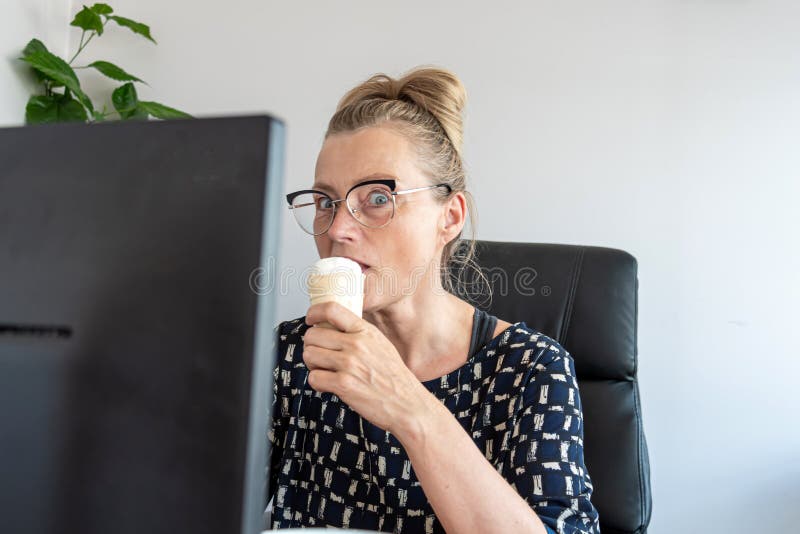 A Busy Office Woman Eats Ice Cream at Her Workplace without ...