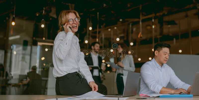 A Busy Professional Team Collaboratively Working Together in a Modern ...