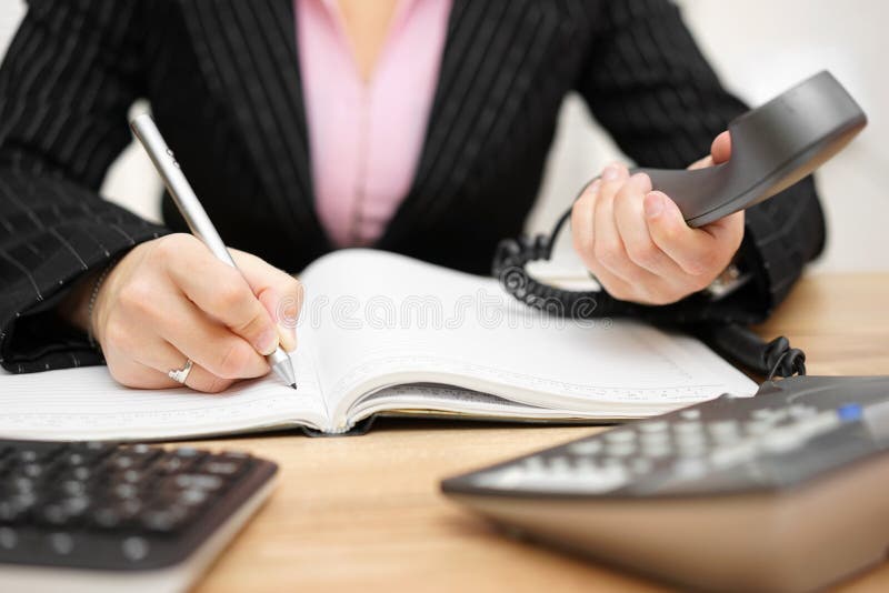 Busy Secretary is Answering Call and Writing Memo Stock Photo - Image ...
