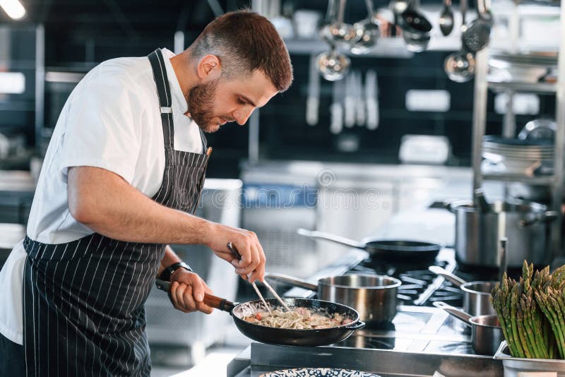 Busy at Work. Chef is on the Kitchen Preparing Food Stock Photo - Image ...