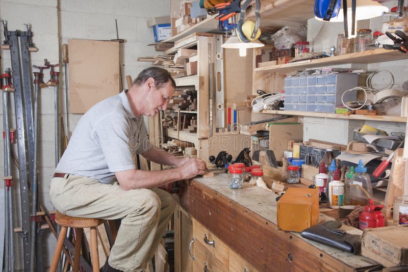 Man Sitting at Workbench in Workshop Stock Photo - Image of plane ...