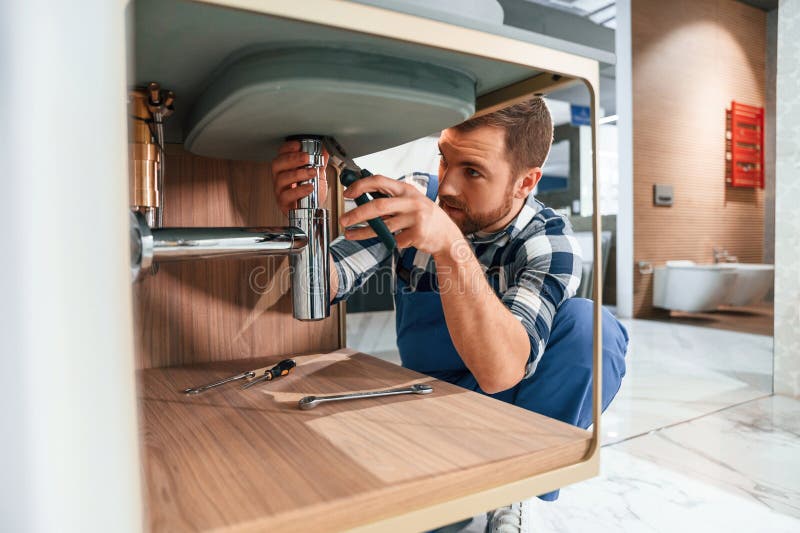 Busy Worker in Blue Uniform is in the Bathroom Stock Photo - Image of ...