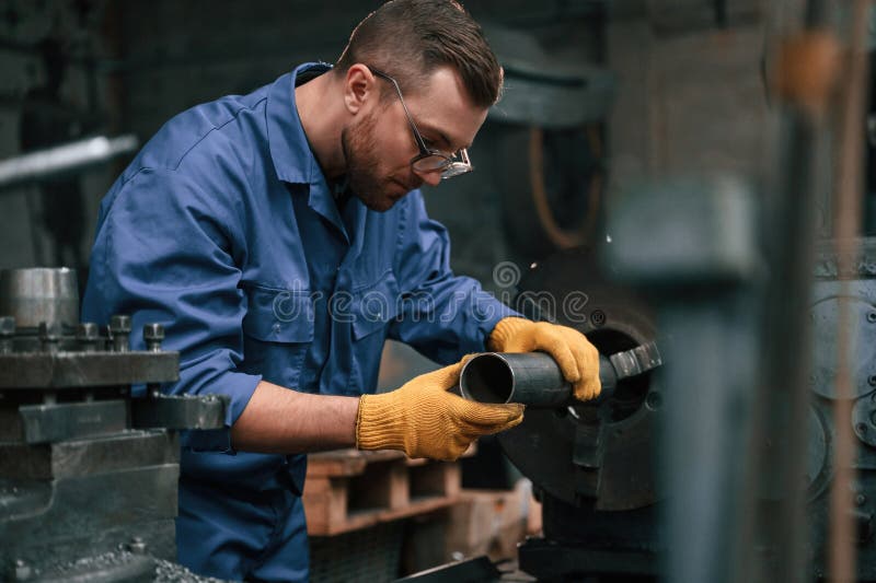 Busy by Working with Automatic Machine. Man at Factory and in Blue ...