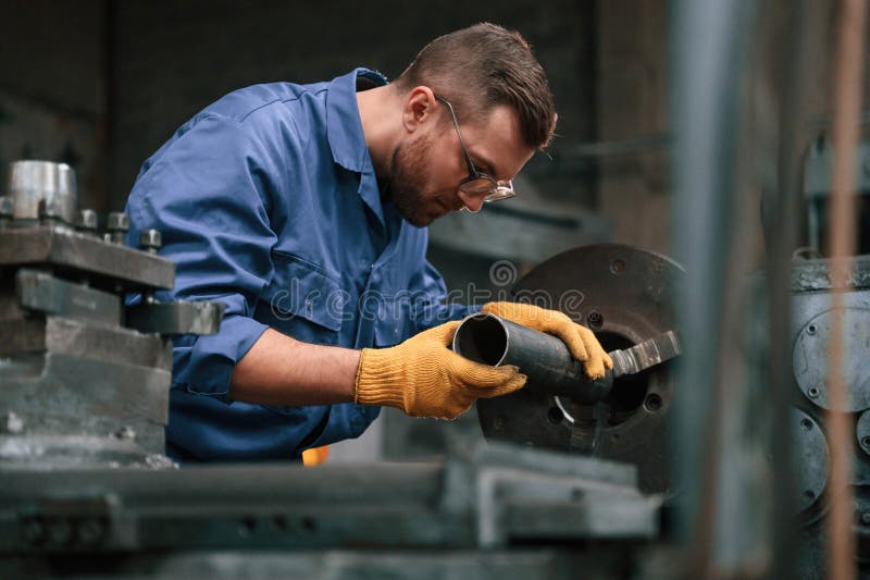Busy by Working with Automatic Machine. Man at Factory and in Blue ...