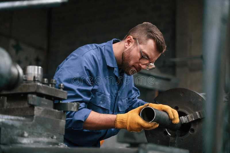 Busy by Working with Automatic Machine. Man at Factory and in Blue ...