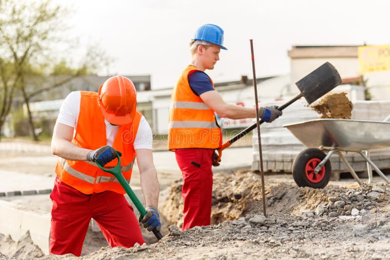 Busy young builders stock image. Image of ground, paving - 54646989
