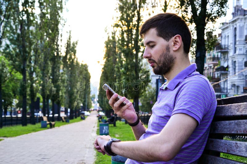 Busy Young Man with Watch Looking at the Phone Outdoors Stock Image ...