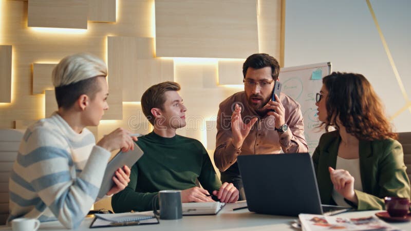 A Busy Team of Creatives Working Together and Sharing Information in an ...