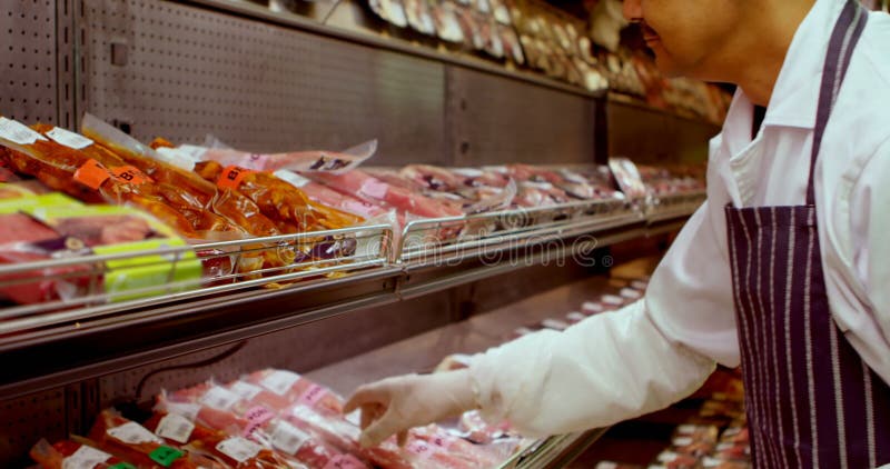 Butcher Arranging Wrapped Meat in Rack at Shop 4k Stock Video - Video ...