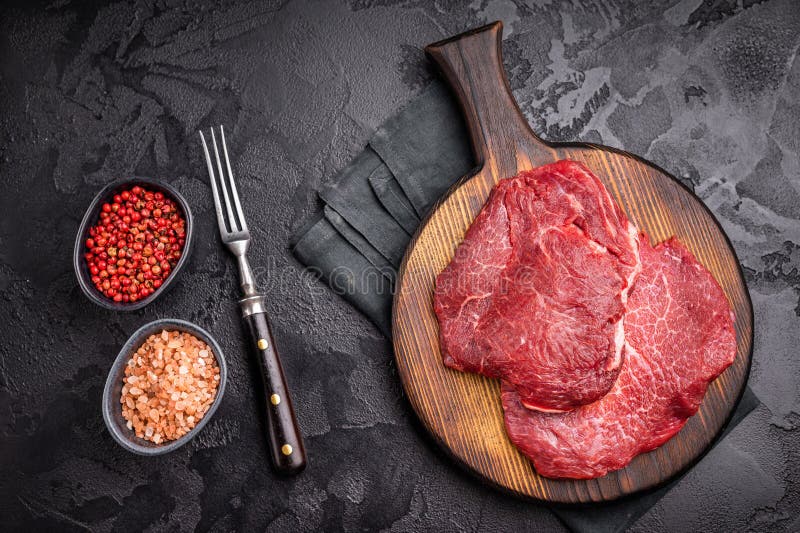 Butcher Board with Raw Beef Cheeks, Uncooked Meat. Black Background ...