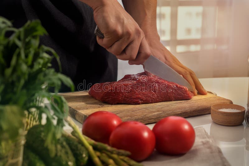 Butcher Cutting Beef in the Kitchen Stock Photo - Image of rosemary ...