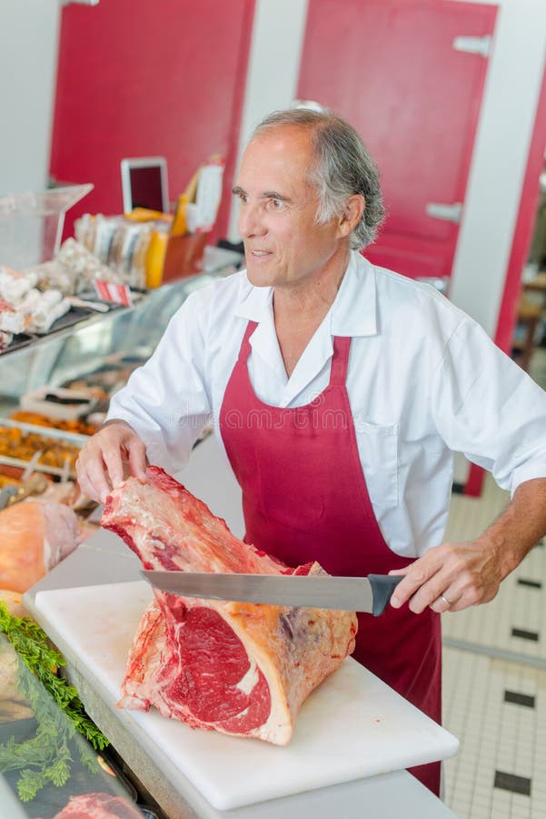 Butcher cutting meat stock image. Image of left, service - 277793193
