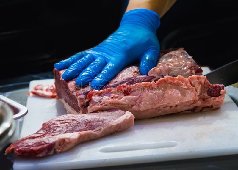 Butcher Cutting Raw Meat with Knife in the Kitchen Stock Image - Image ...